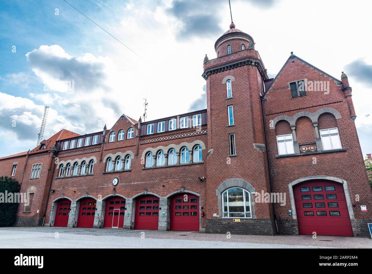 Facade of an old classic fire station with red doors in Malmo, Sweden ...