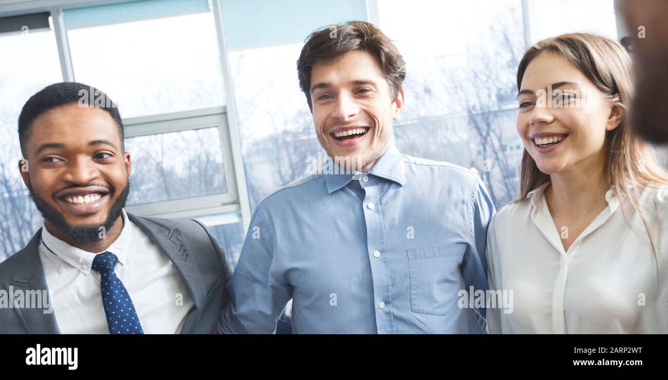 Happy colleagues bonding in circle and smiling Stock Photo - Alamy