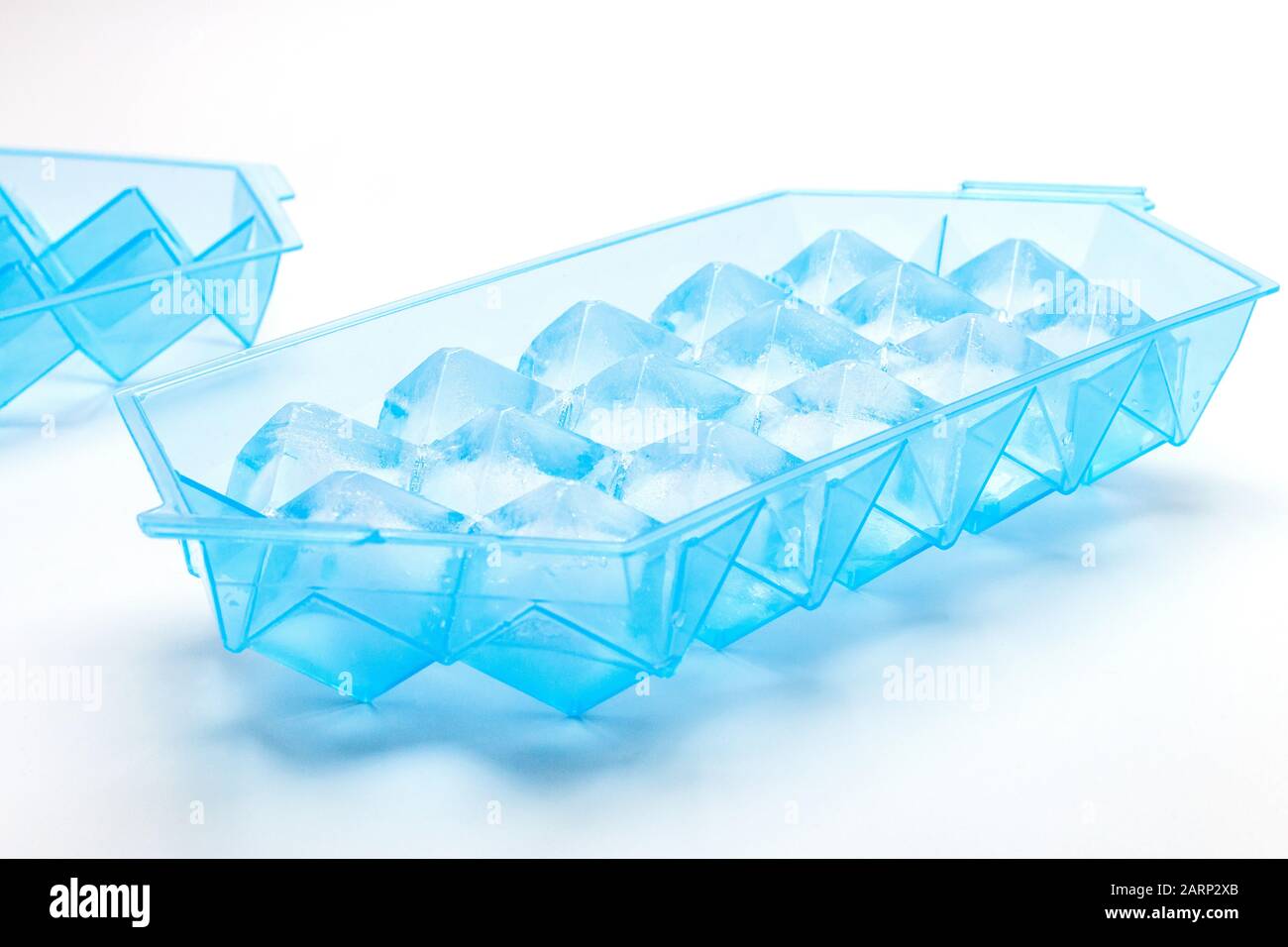 a blue reusable plastic ice maker with cover holding fresh ice cubes ...
