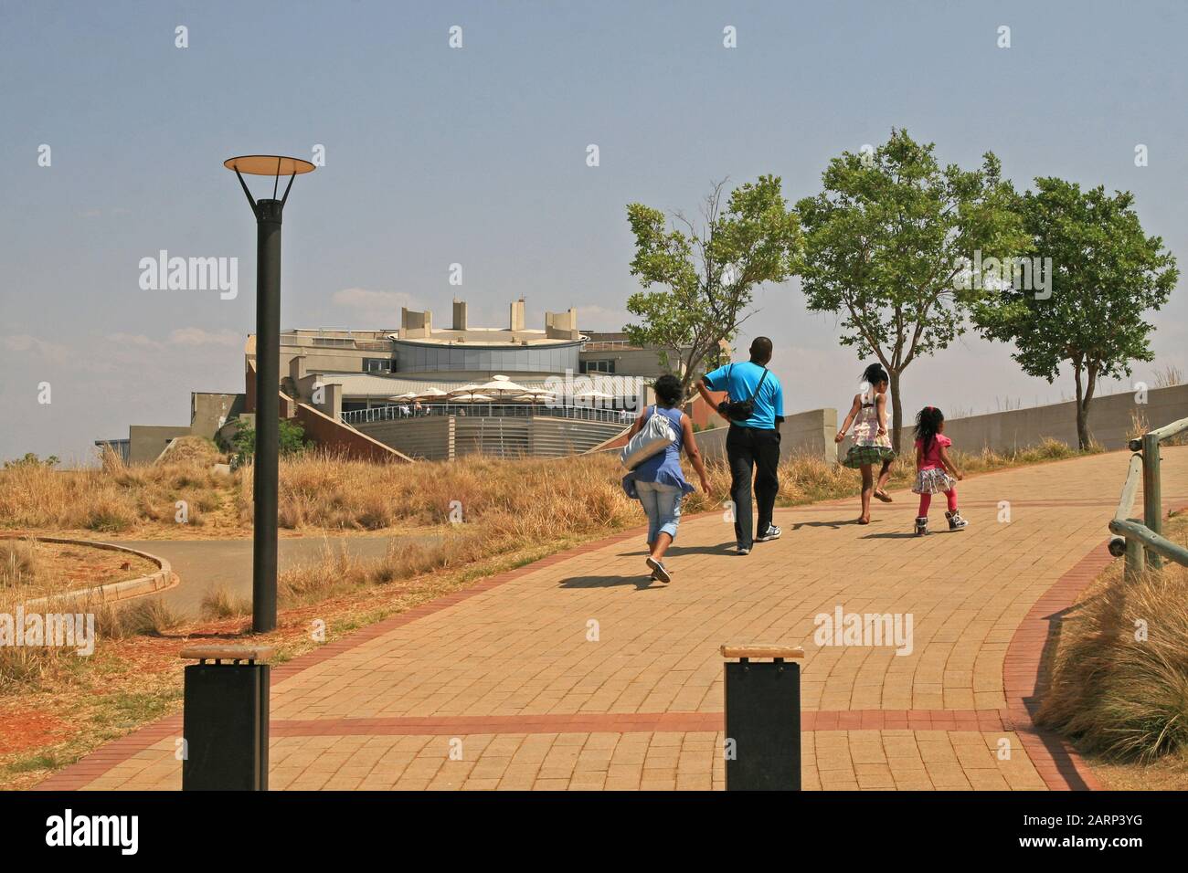 Tourists walking on brick path at the back of the main museum of The ...