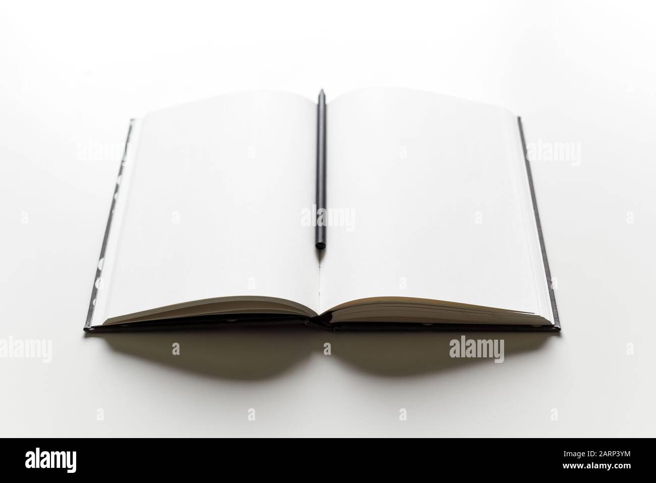 Empty blank white page in a paper note book with pencil for writing ...