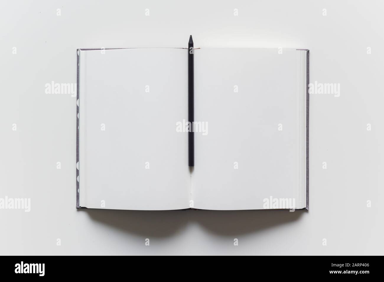 Empty blank white page in a paper note book with pencil for writing ...