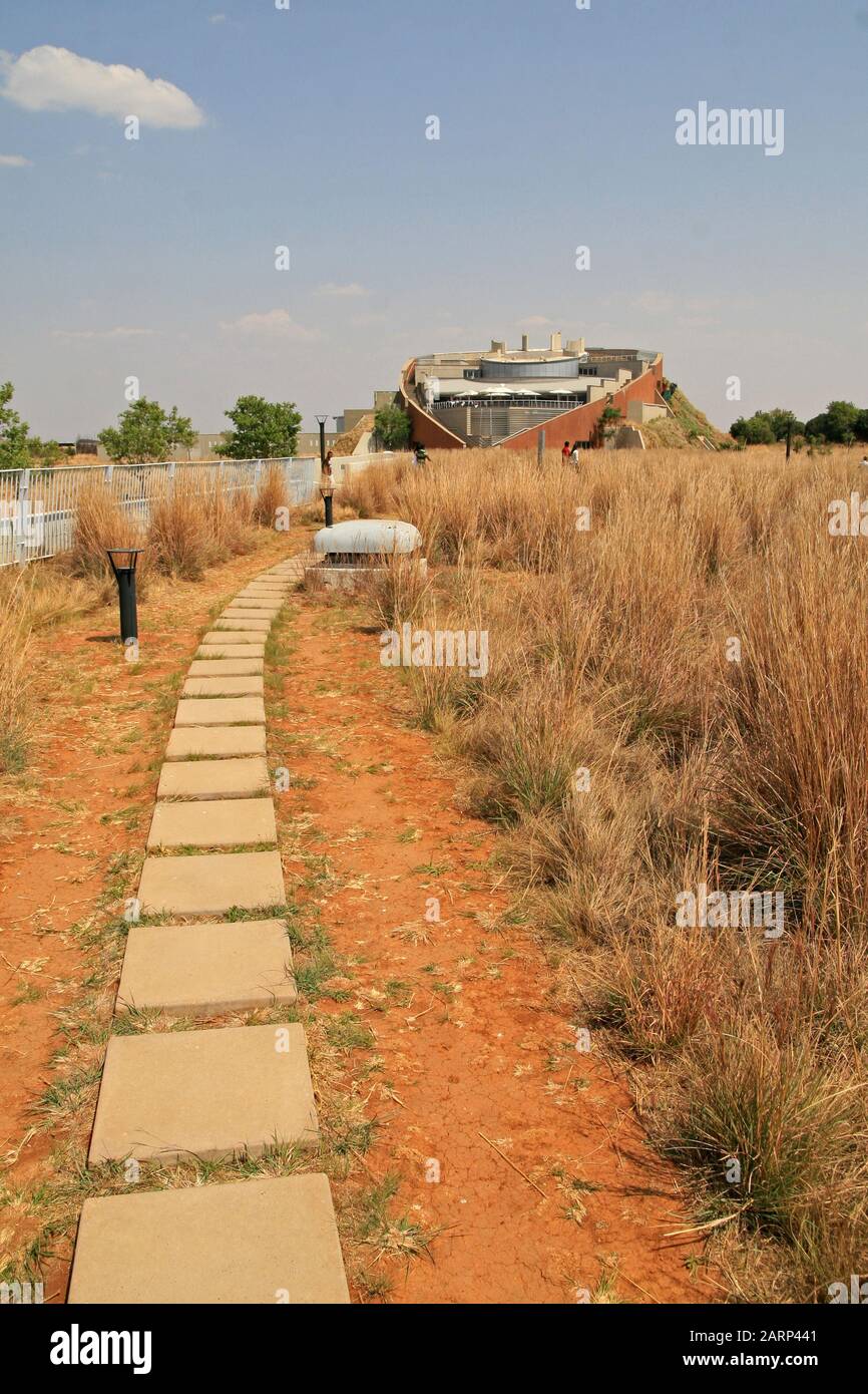 Back of the main museum of The Cradle of Humankind from stone path in ...