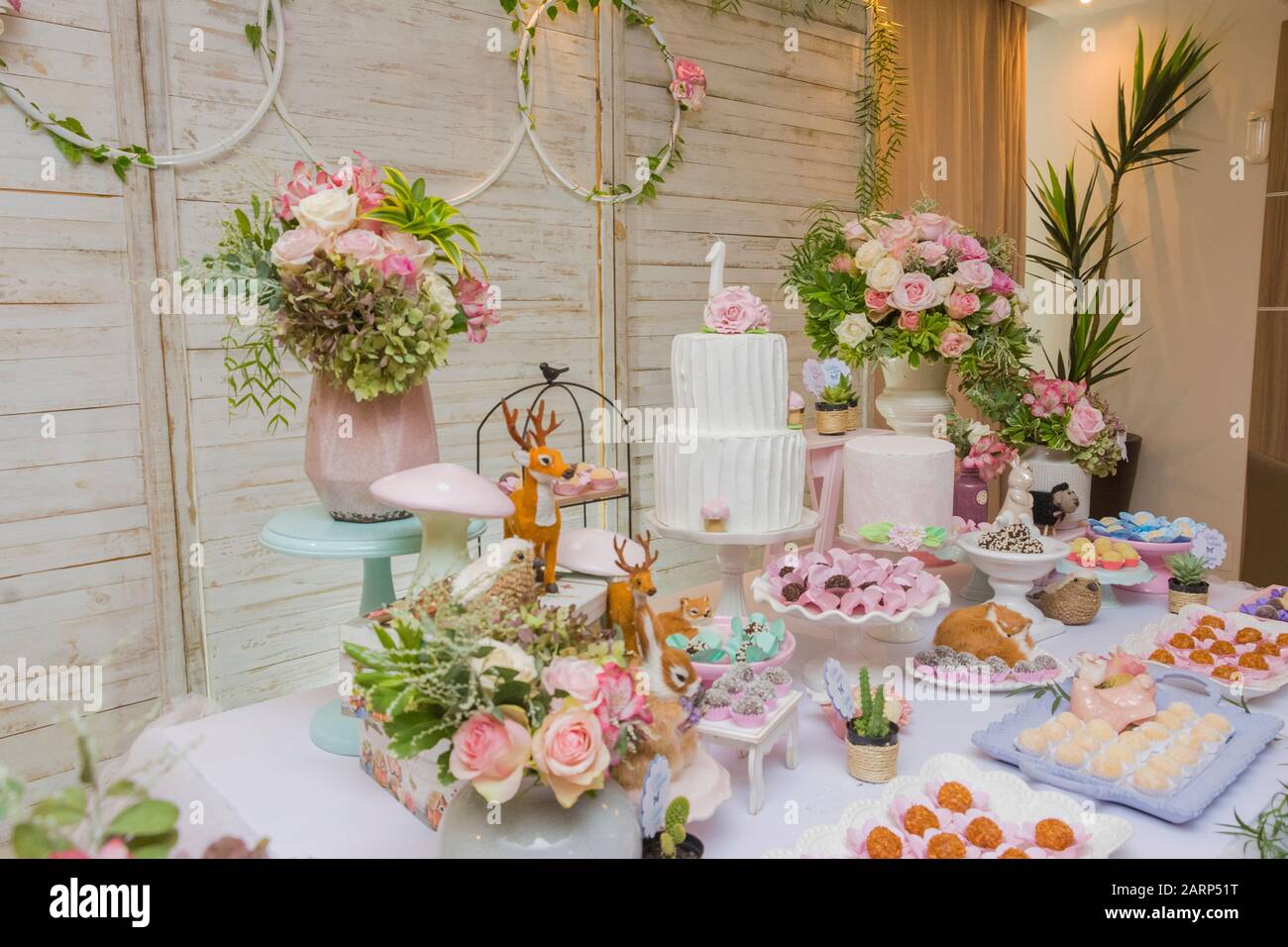 Details of luxurious table of sweets and birthday cake decorated with ...