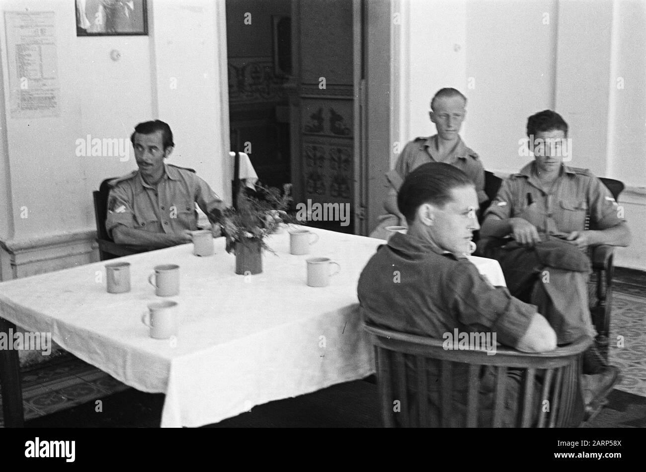 Four soldiers sitting around a table on which mugs stand Date: 1947/01 ...