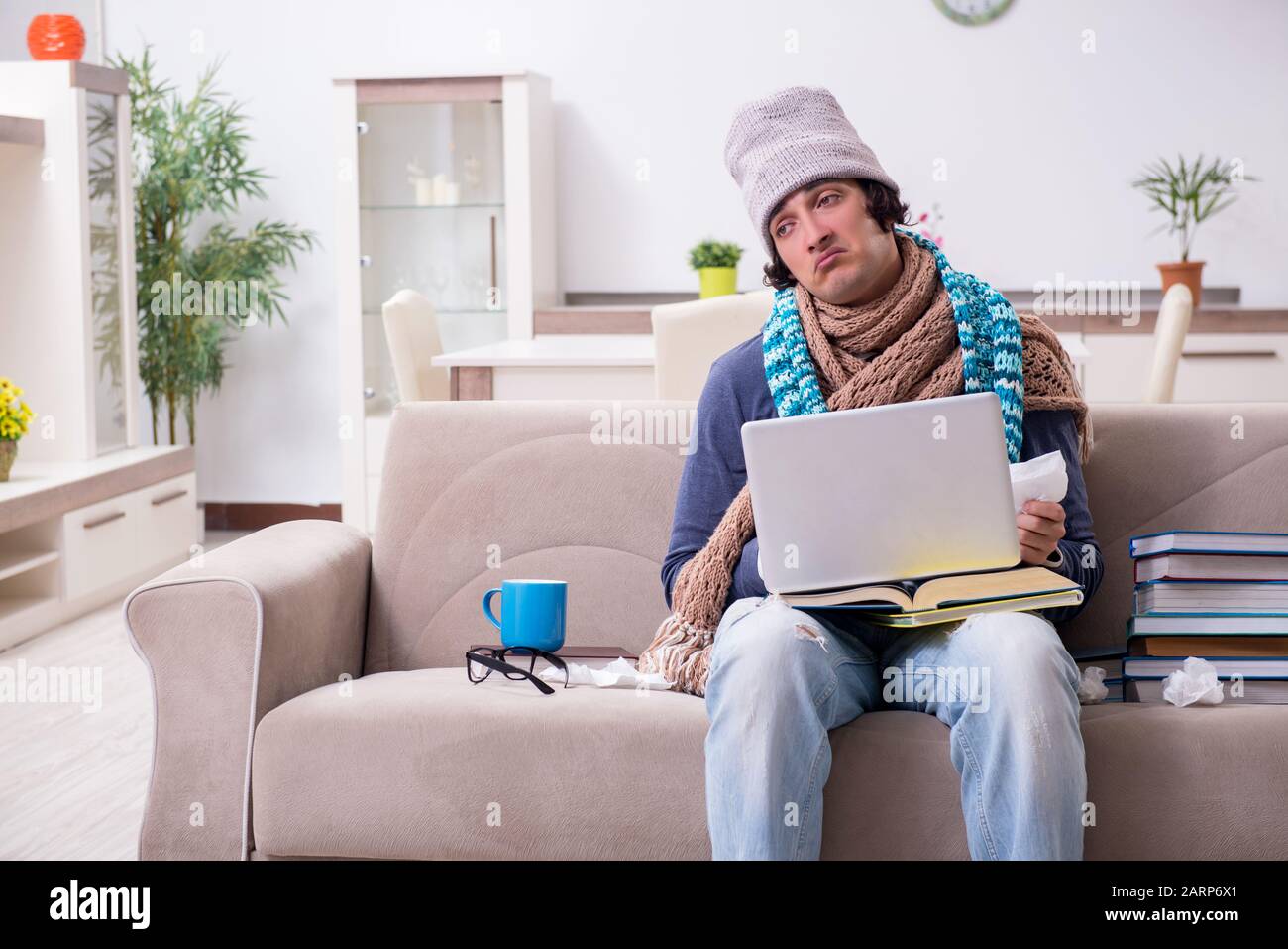 The sick male student suffering at home Stock Photo - Alamy