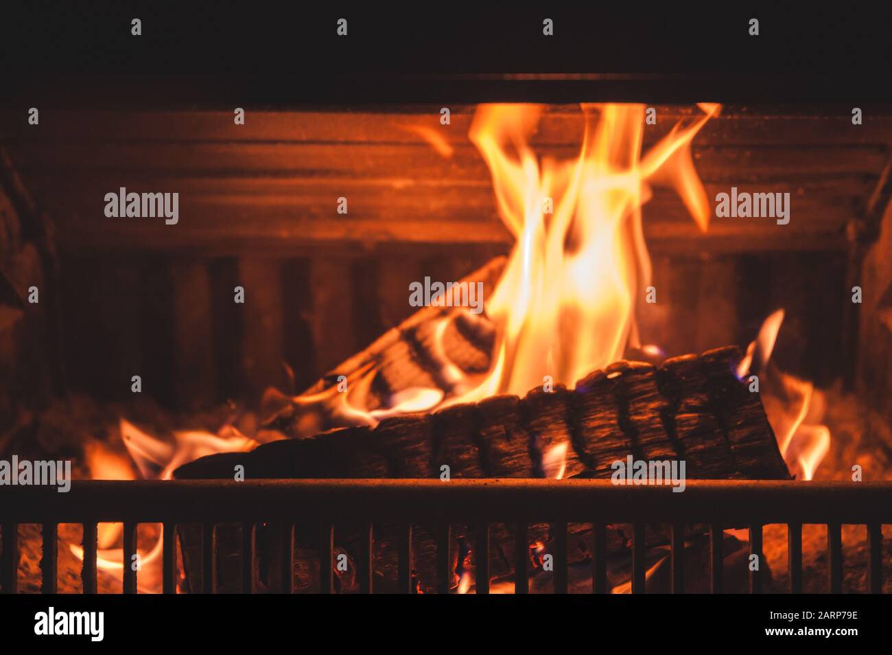 Burning fireplace at night, close-up photo with soft selective focus ...