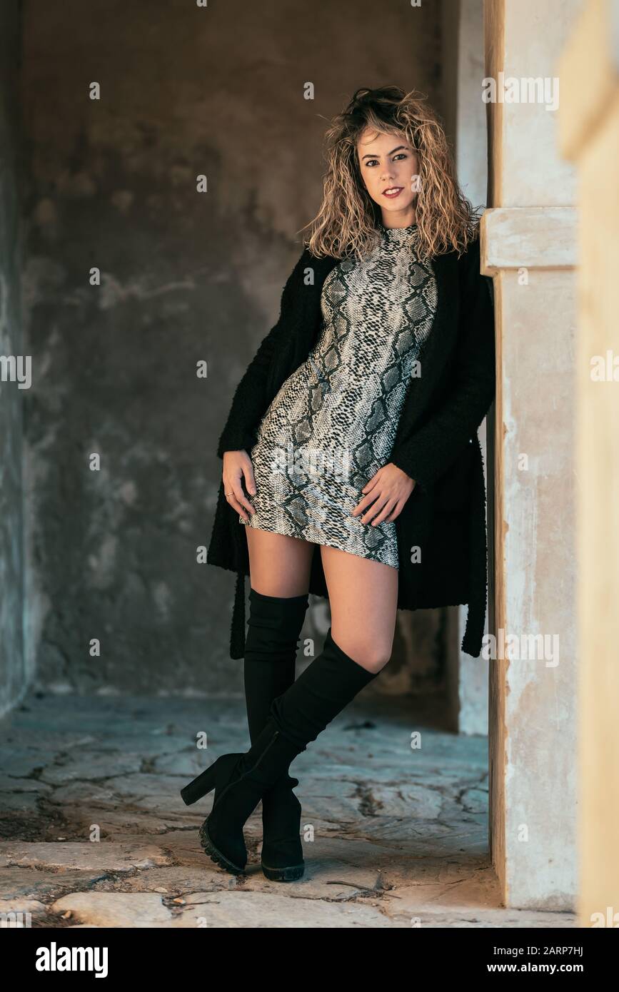 curly blonde woman lean against column with copy space for text Stock ...