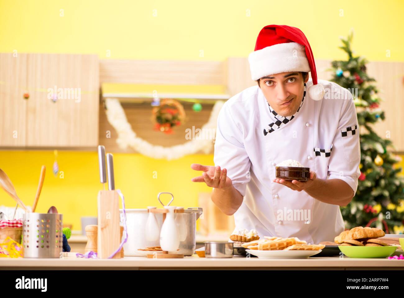 The young chef husband working in kitchen at christmas eve Stock Photo ...