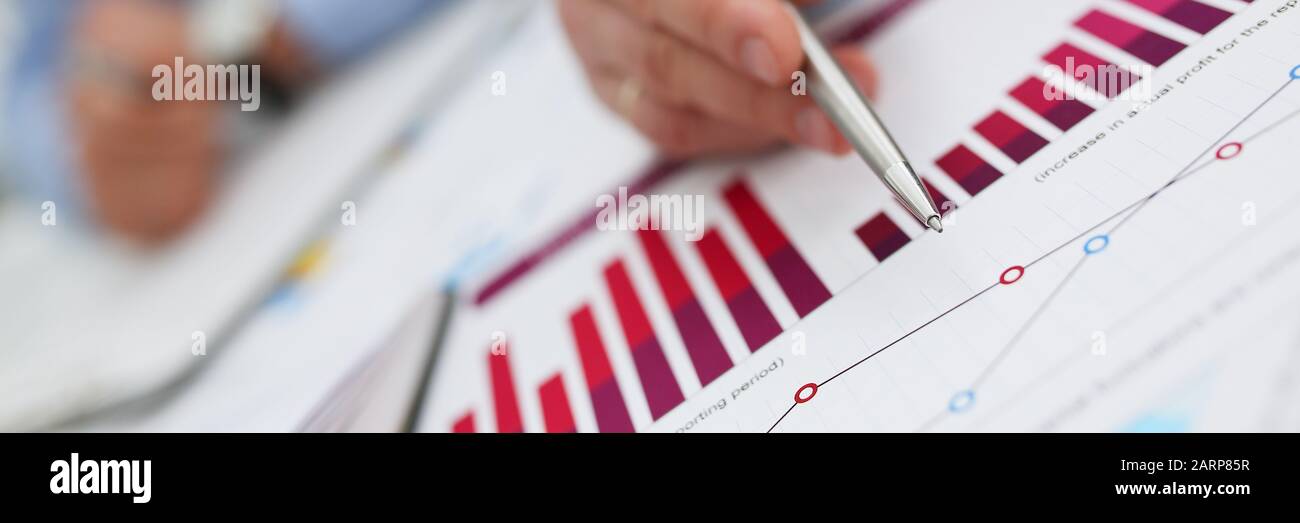 Group of people deliberate on problem with infographics Stock Photo - Alamy