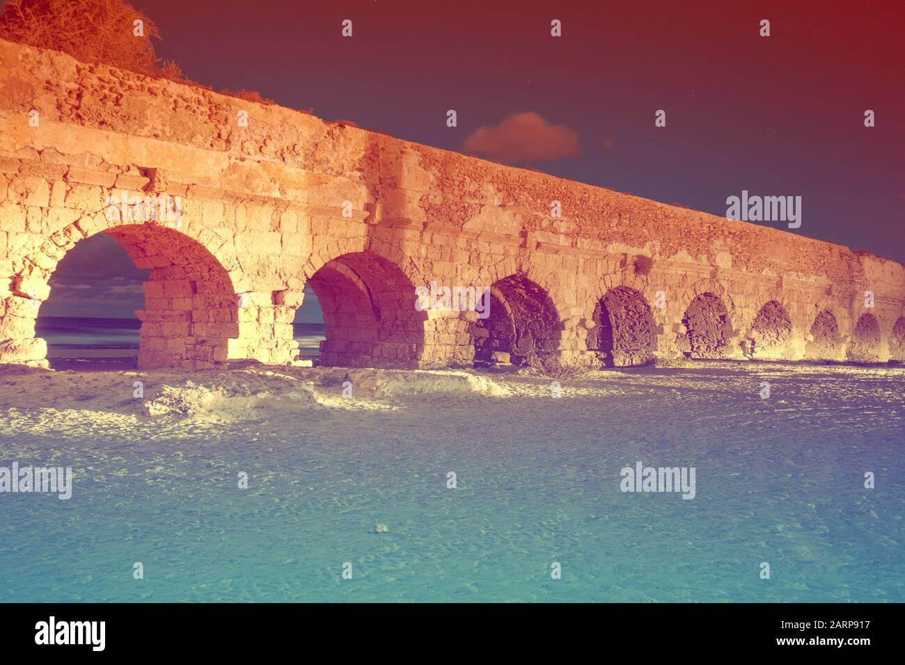 Aqueduct in ancient city Caesarea at sunset. Creative color Stock Photo ...