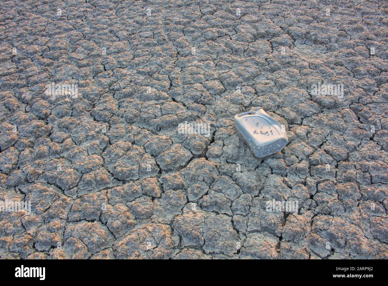 Gallon oil on the cracked dry ground. Garbage. Environmental pollution ...