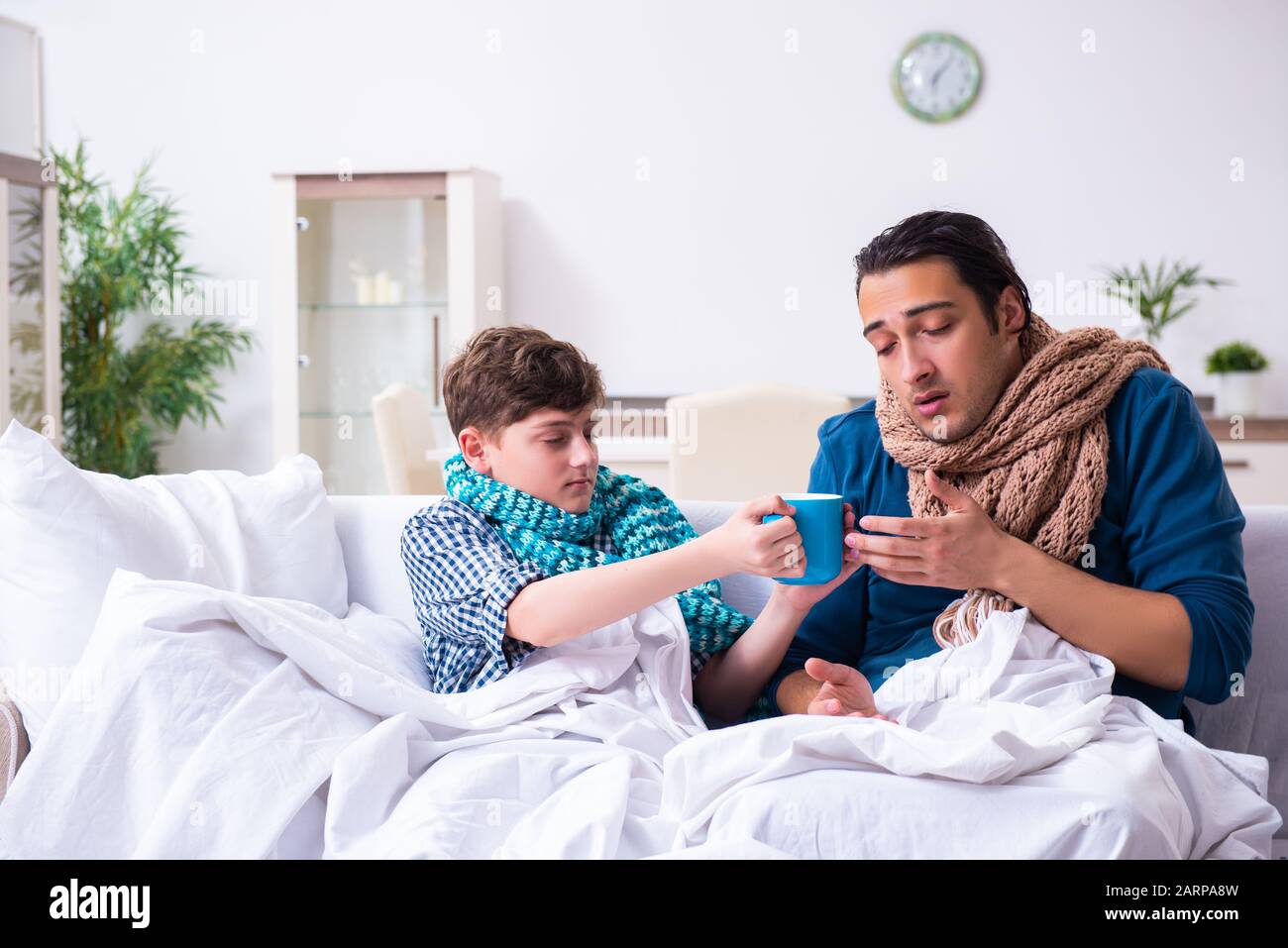 The young father caring for sick son Stock Photo - Alamy