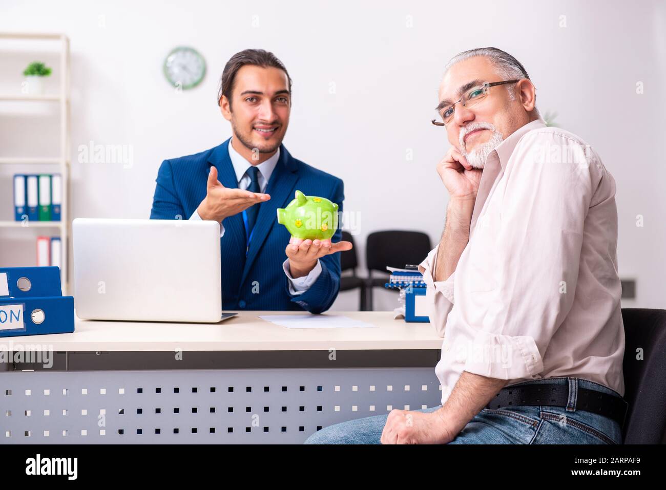 The financial advisor giving retirement advice to old man Stock Photo ...