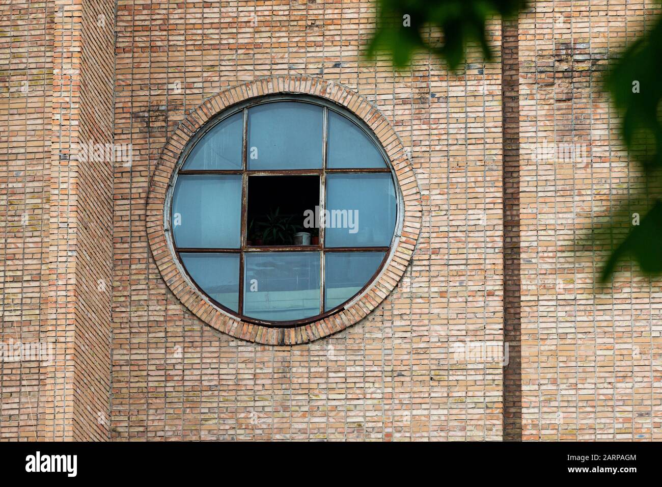 creative studio in the attic and a round window Stock Photo - Alamy