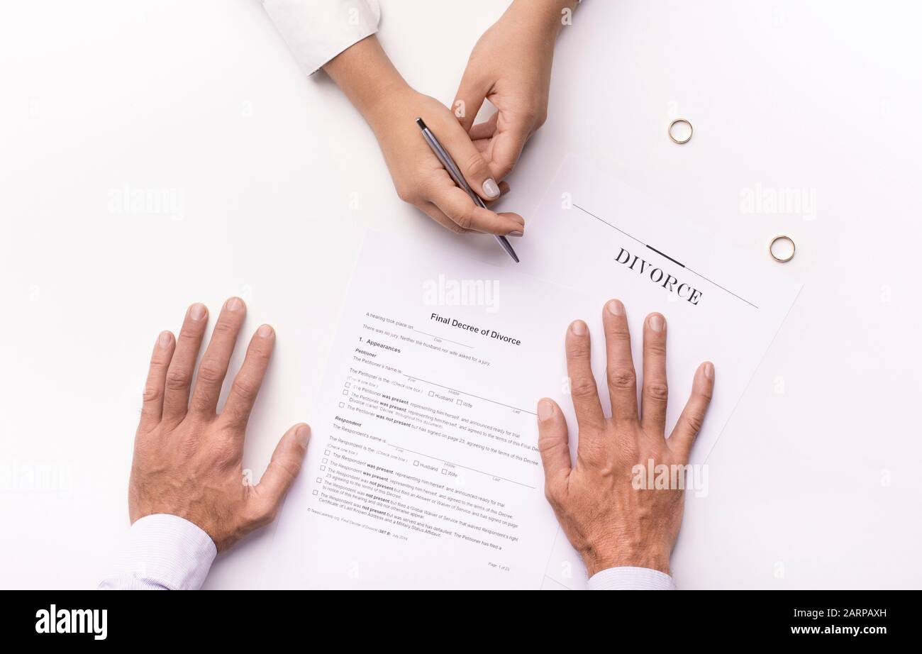 Hands of wife, husband signing decree of divorce Stock Photo - Alamy