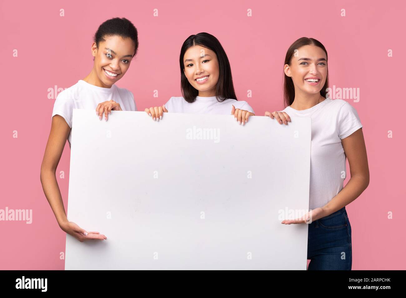 Three Girls Holding Blank White Poster Standing, Studio Shot, Mockup ...