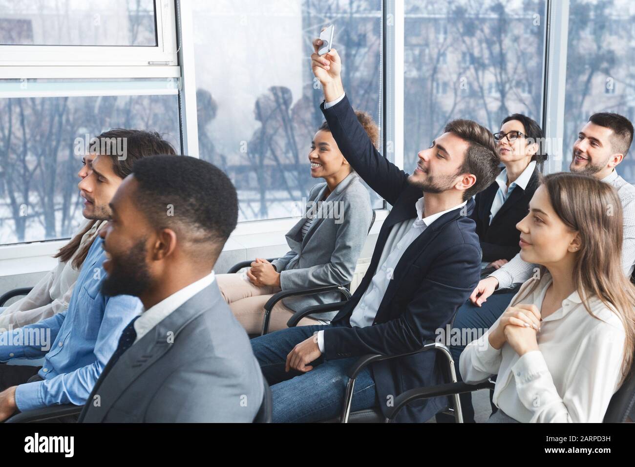 Young entrepreneur filming business lecture on phone Stock Photo - Alamy