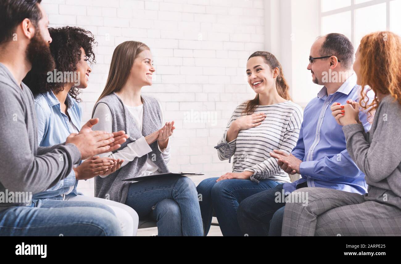Happy woman sharing her progress with with group in rehab Stock Photo ...
