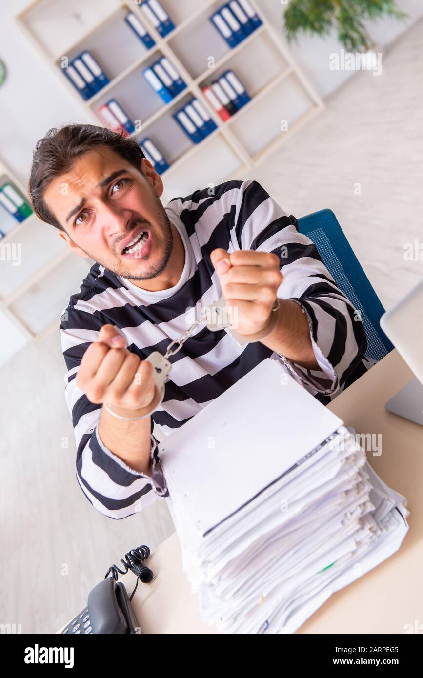 The young employee feeling like prisoner at work Stock Photo - Alamy