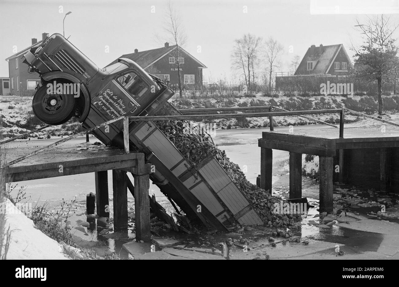 Truck with trailer, loaded with seven tons of beet, dropped by a bridge ...