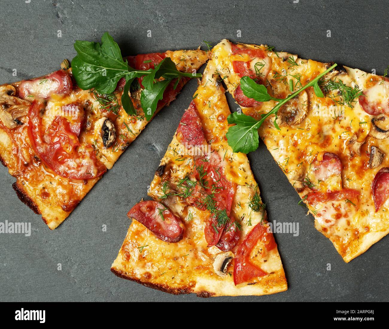 baked round pizza with smoked sausages, mushrooms, tomatoes, cheese and ...