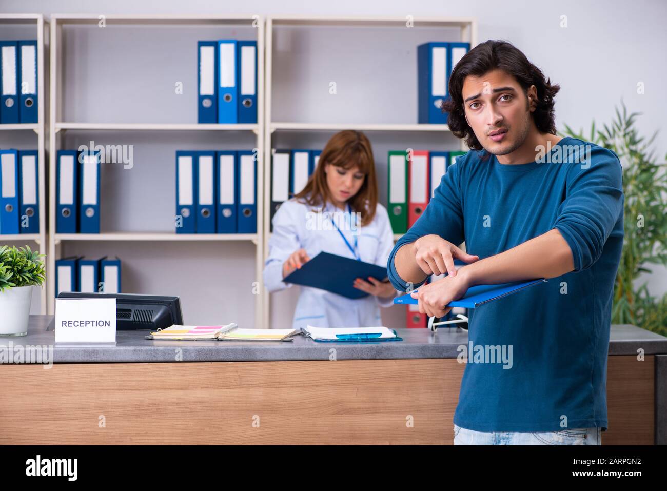 The young patient at the reception in the hospital Stock Photo - Alamy