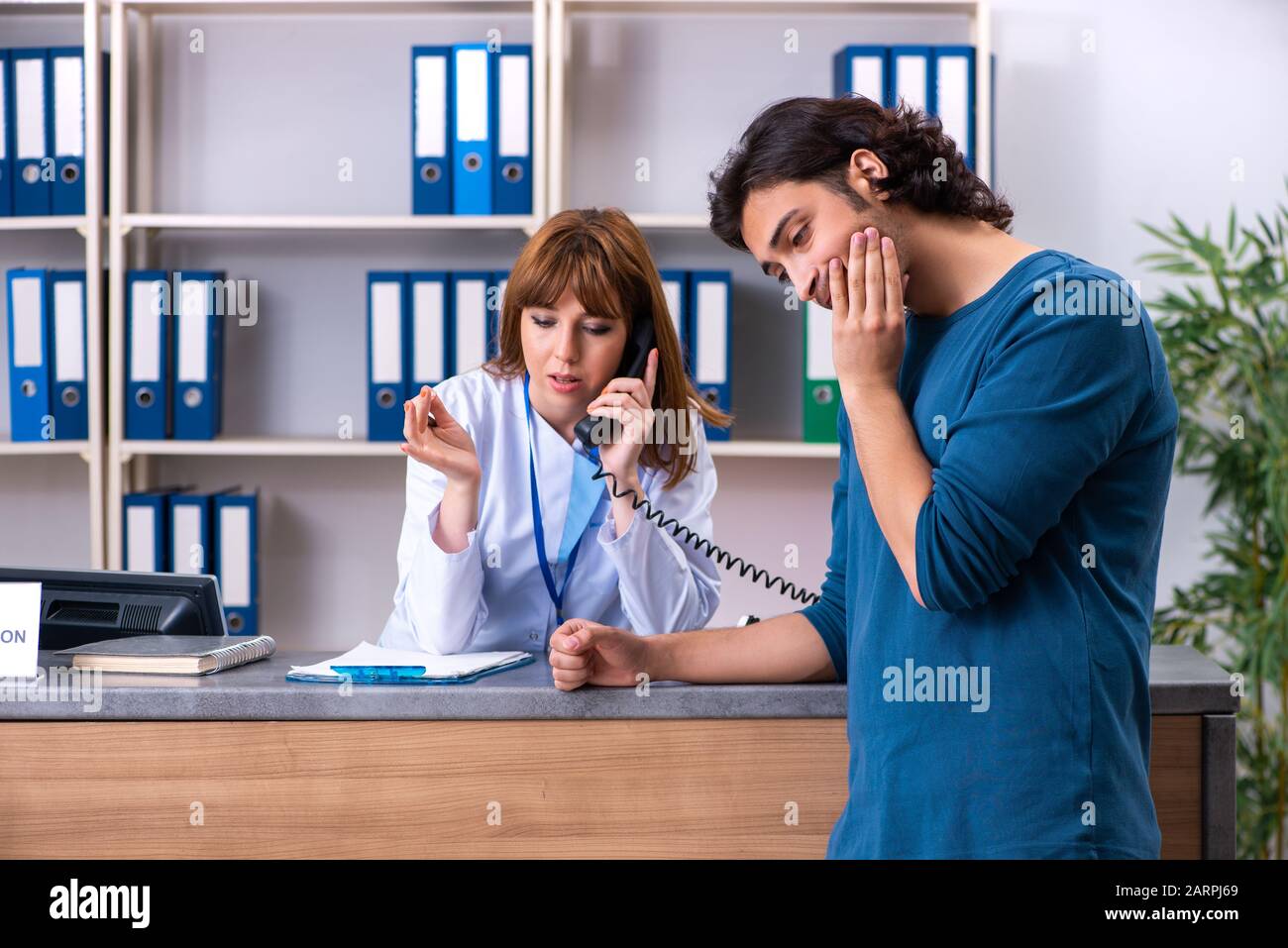 The young patient at the reception in the hospital Stock Photo - Alamy