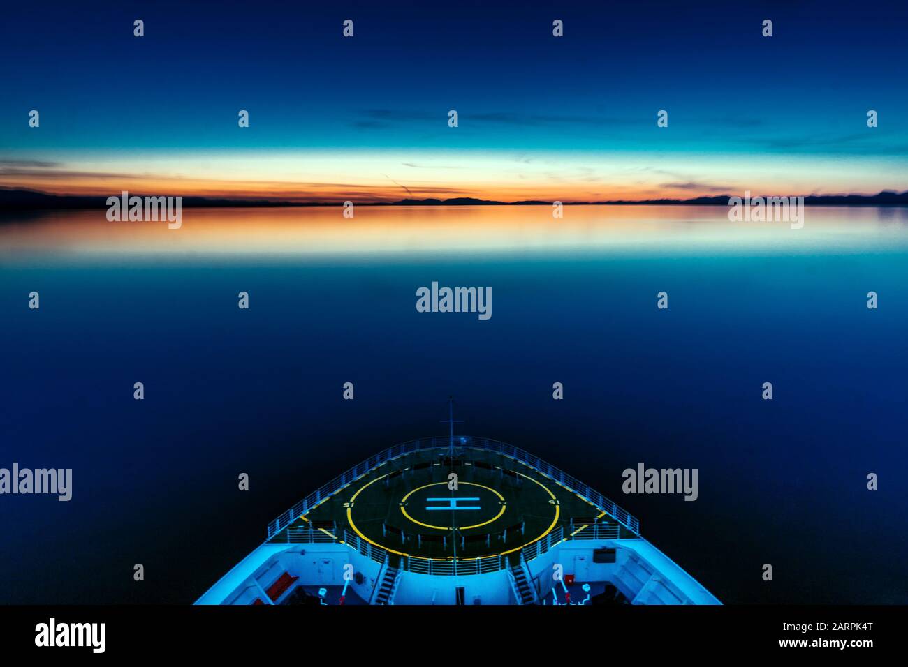 Cruise ship is facing beautiful sunset. Helipad is ready to get a ...