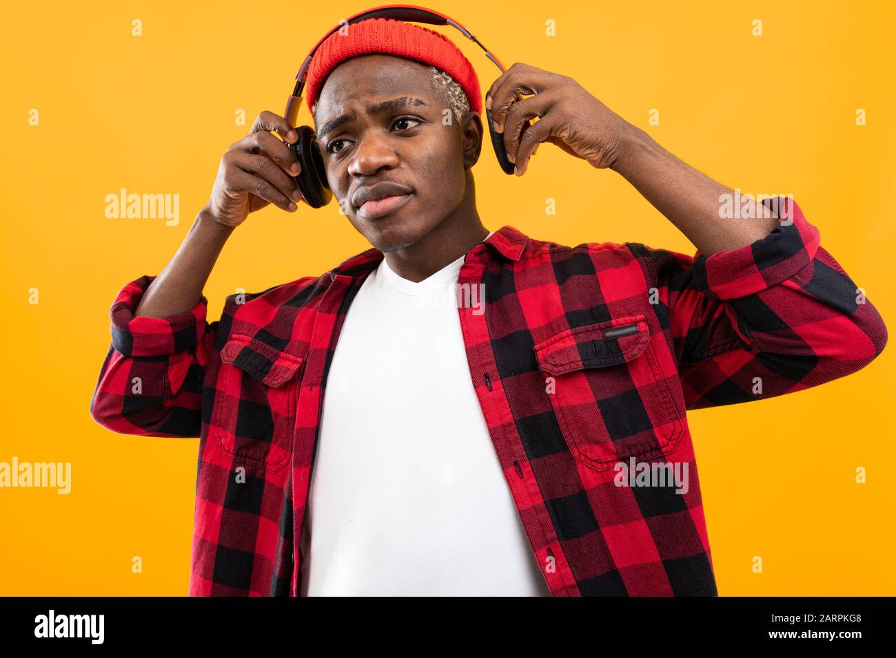 handsome black american man overhears something without headphones ...