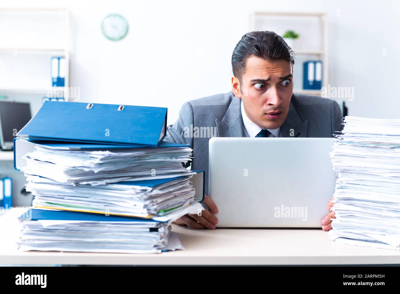 The businessman with heavy paperwork workload Stock Photo - Alamy