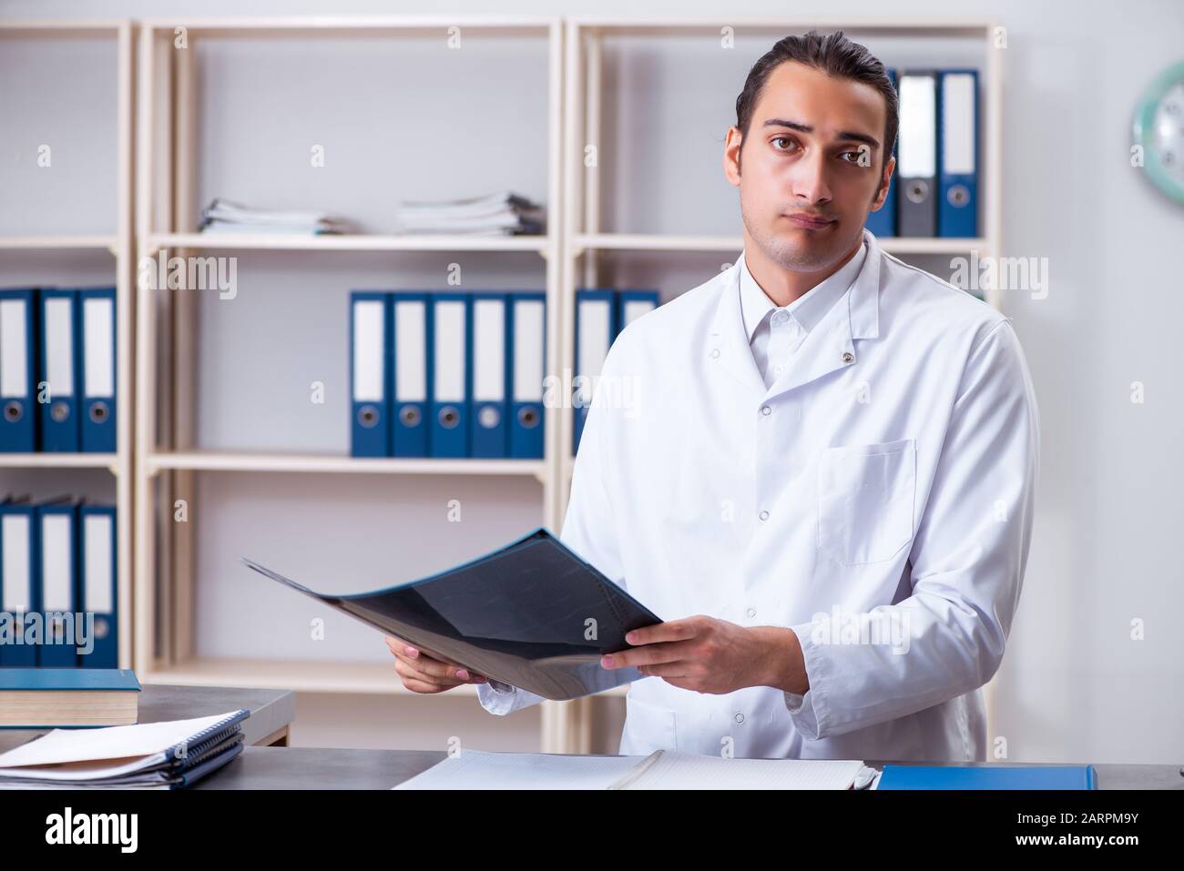The young male doctor at the reception in the hospital Stock Photo - Alamy