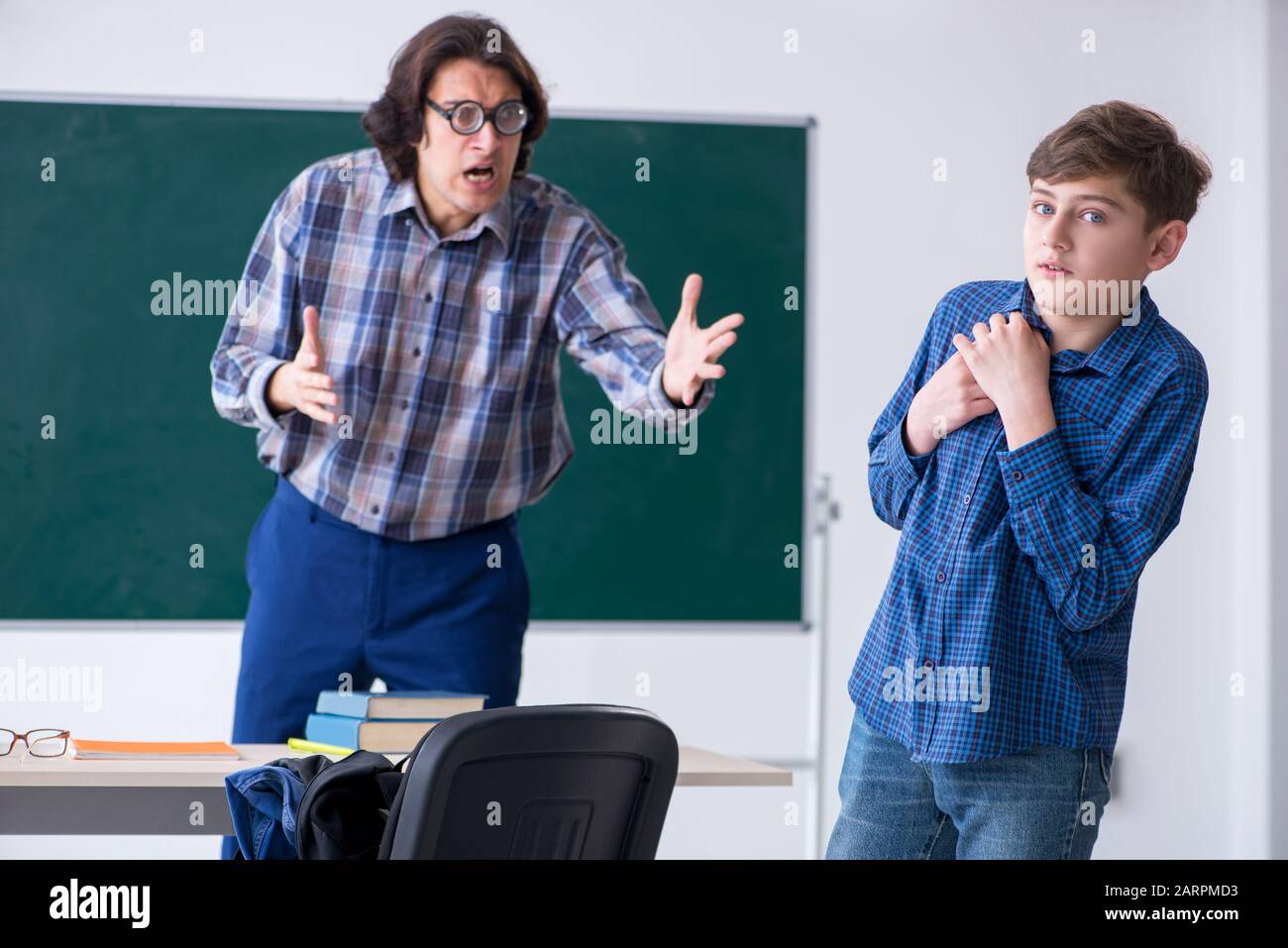 The funny male teacher and boy in the classroom Stock Photo - Alamy