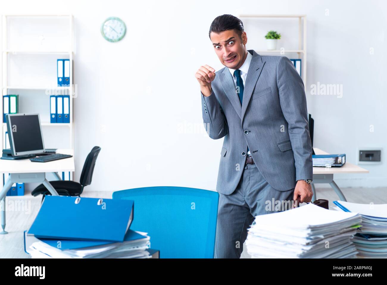 The businessman with heavy paperwork workload Stock Photo - Alamy