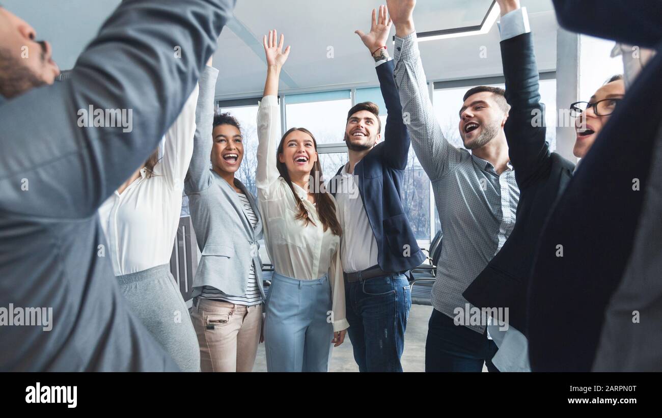 United coworkers raising hands up to celebrate their achievement Stock ...