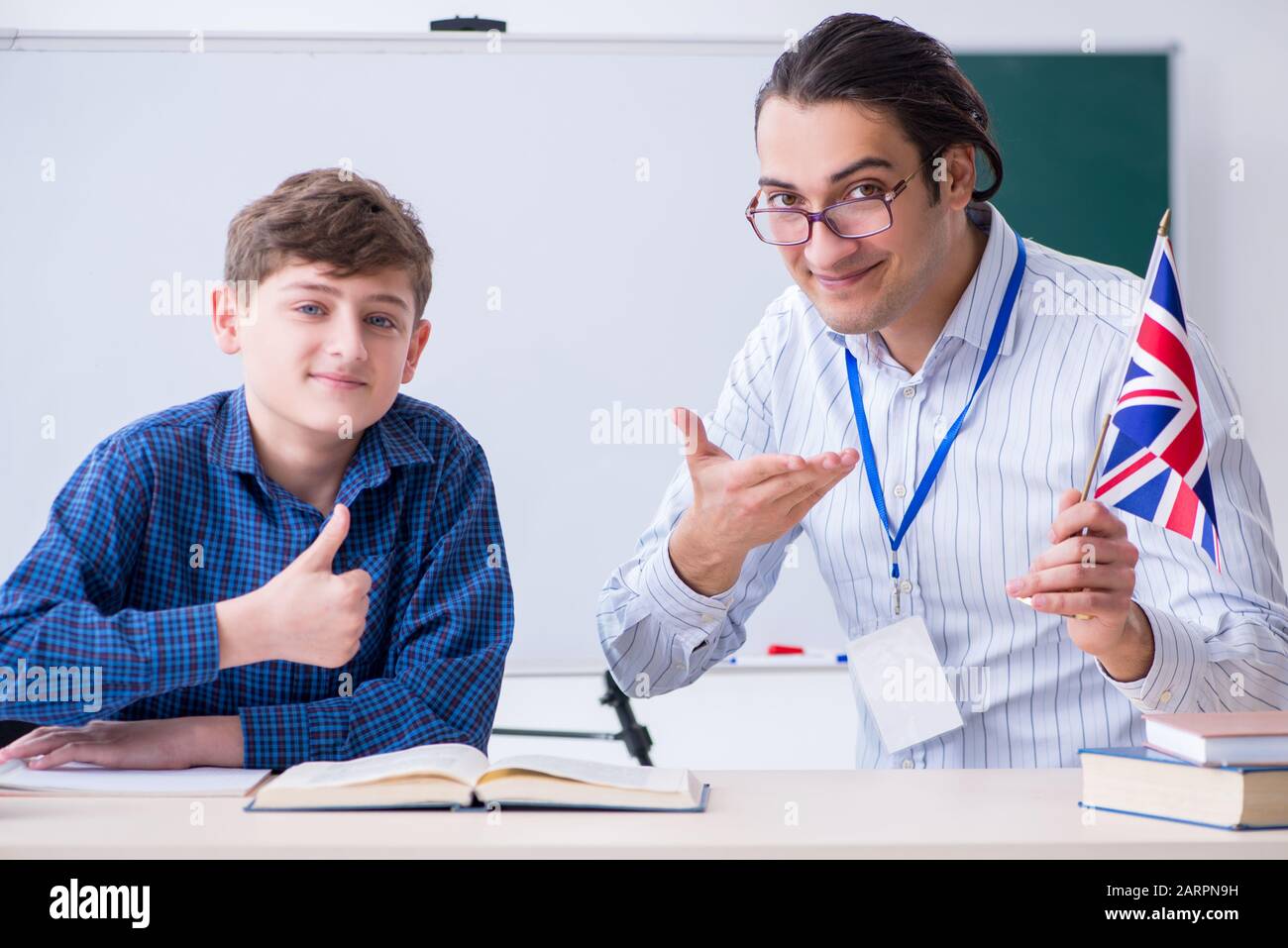 The male english teacher and boy in the classroom Stock Photo - Alamy