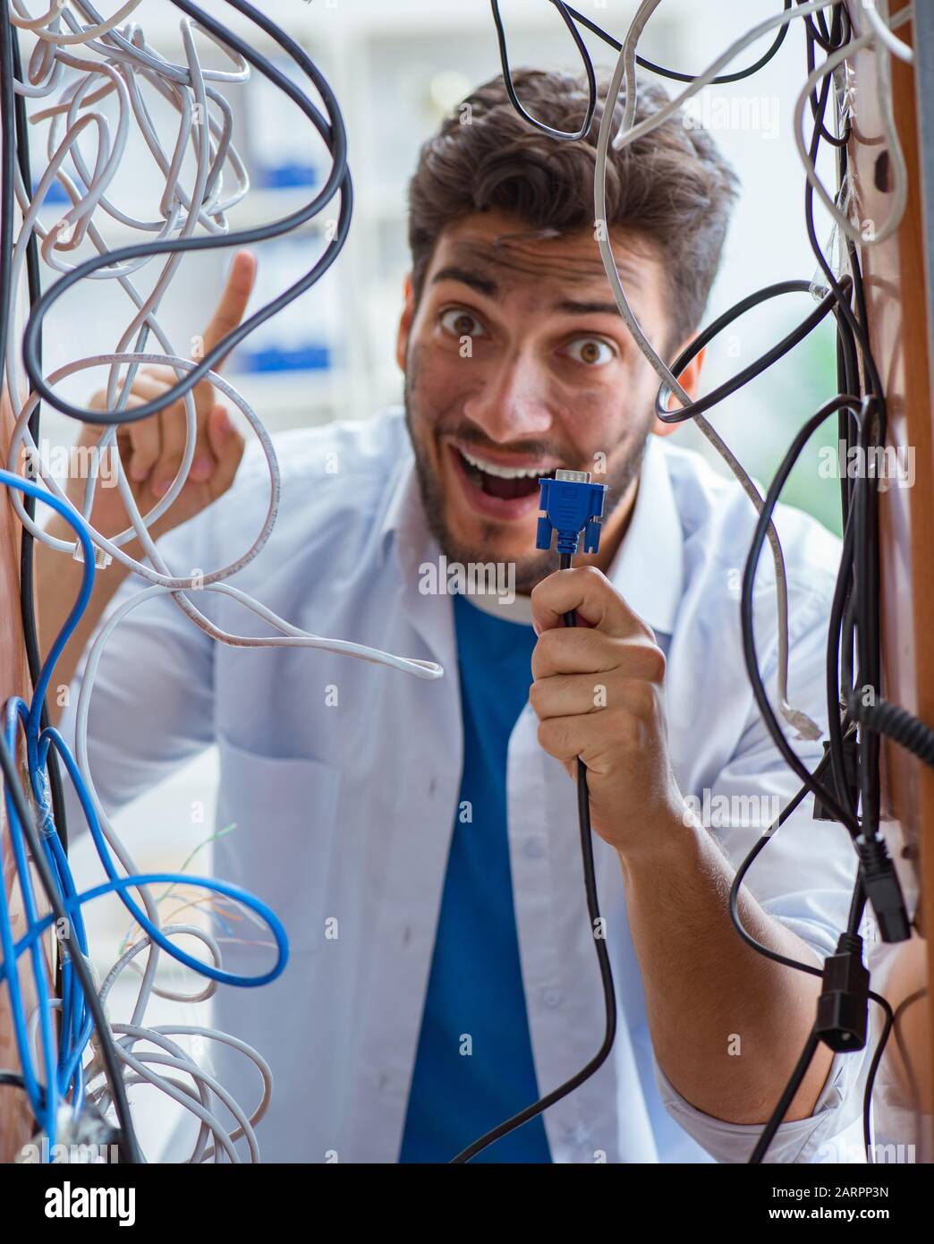 The electrician trying to untangle wires in repair concept Stock Photo ...