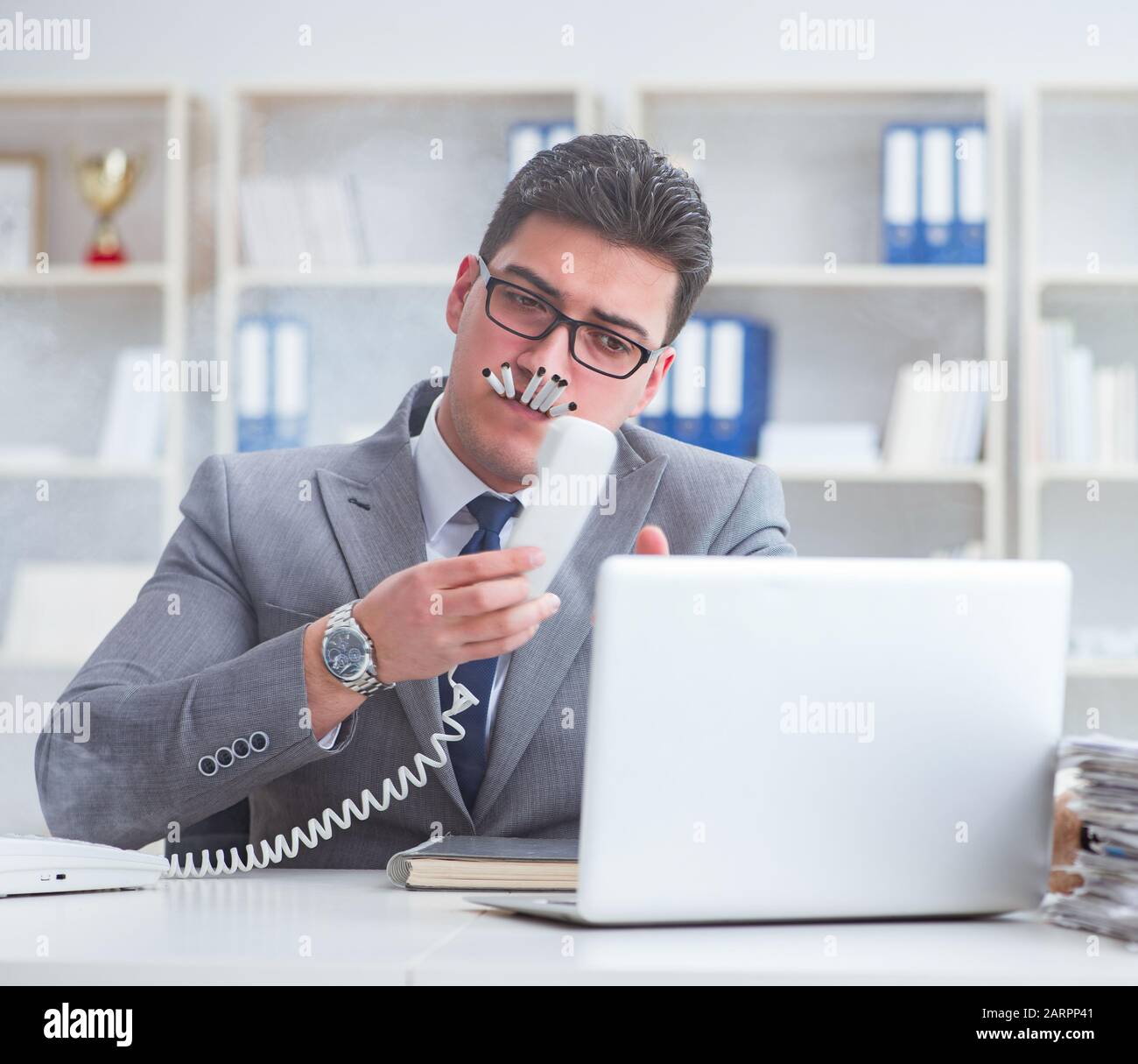 The businessman smoking in office at work Stock Photo - Alamy