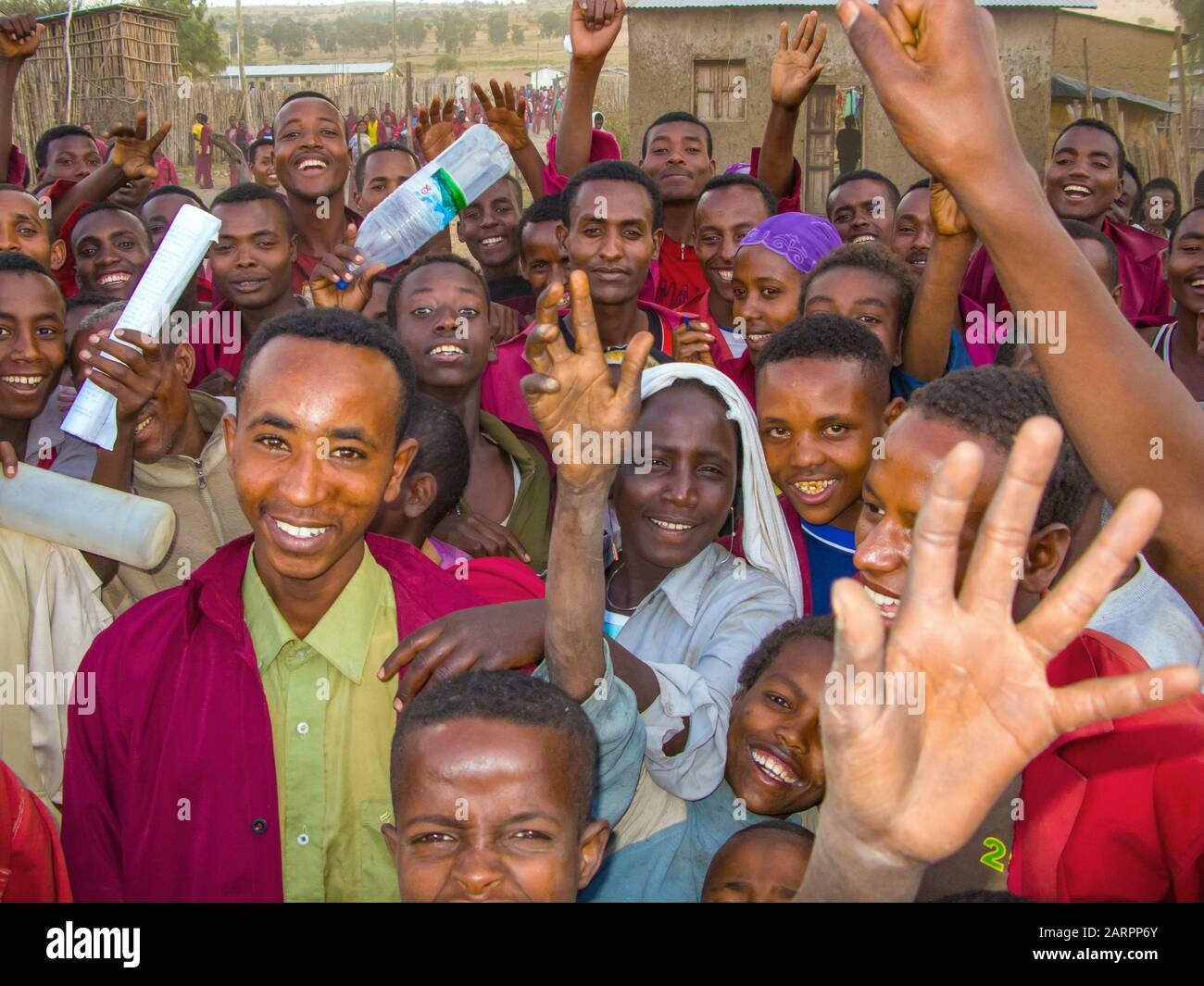 Many African school children and students looking and smiling at the ...