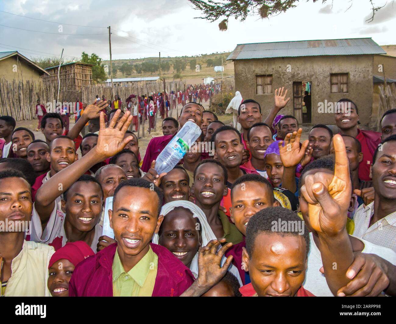 Many African school children and students looking and smiling at the ...