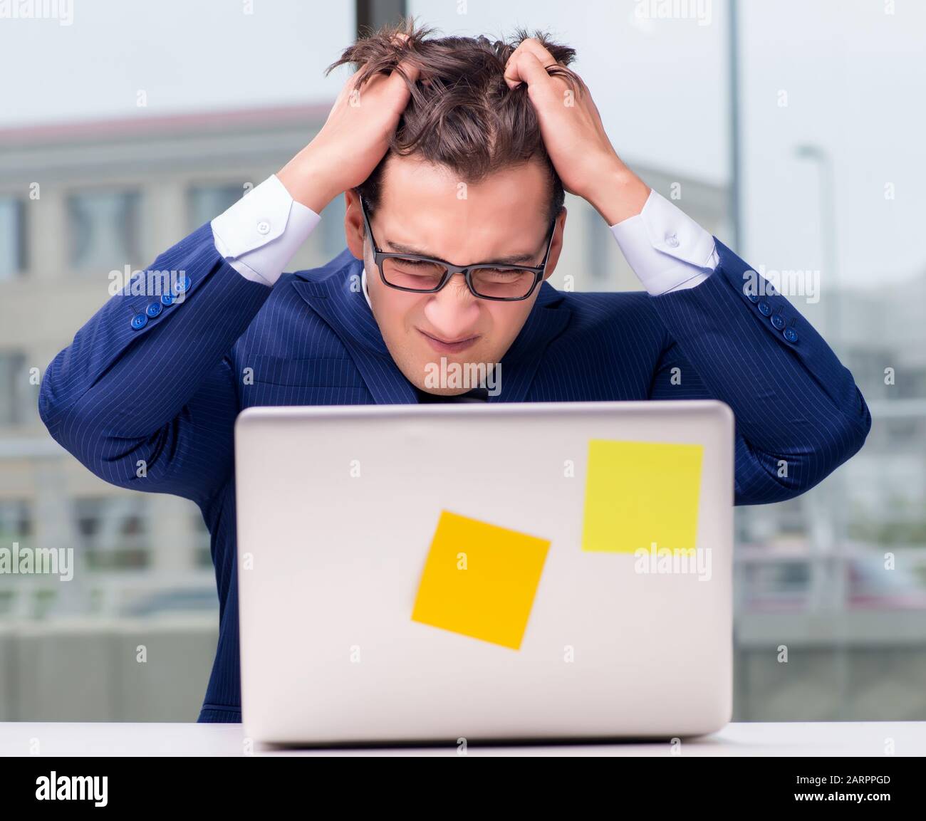 The workaholic businessman overworked with too much work in office ...