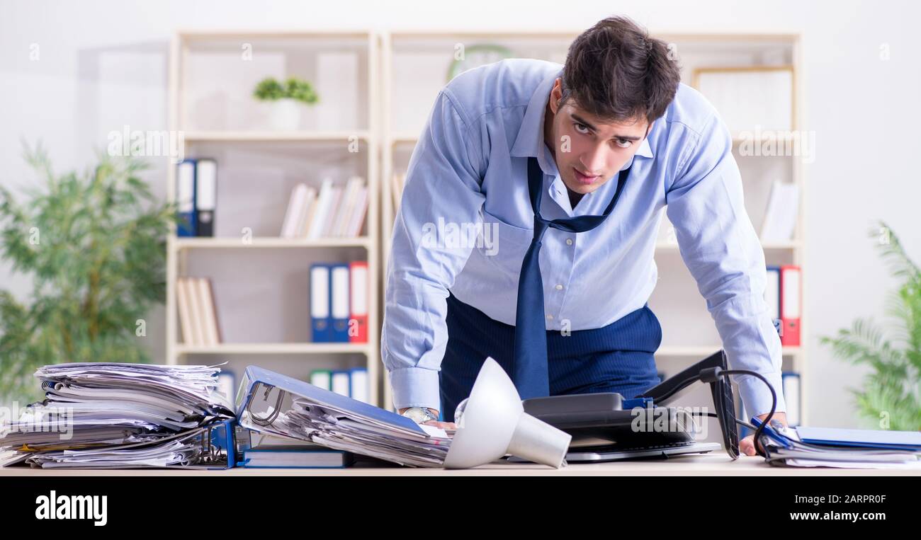 The angry businessman frustrated with too much work Stock Photo - Alamy
