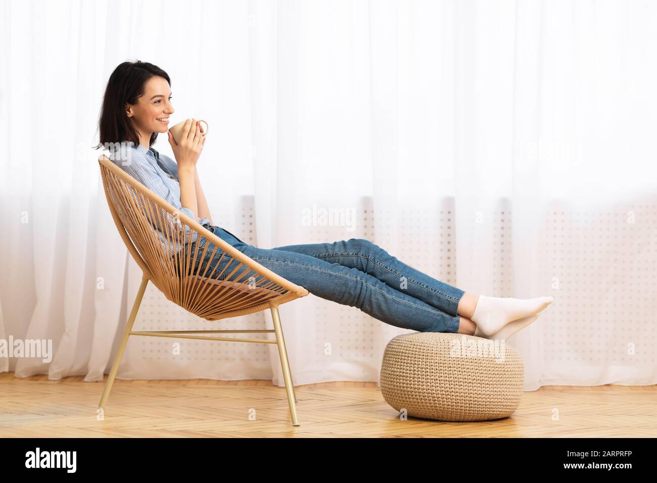 Girl having rest at home with a cup of hot tea Stock Photo - Alamy