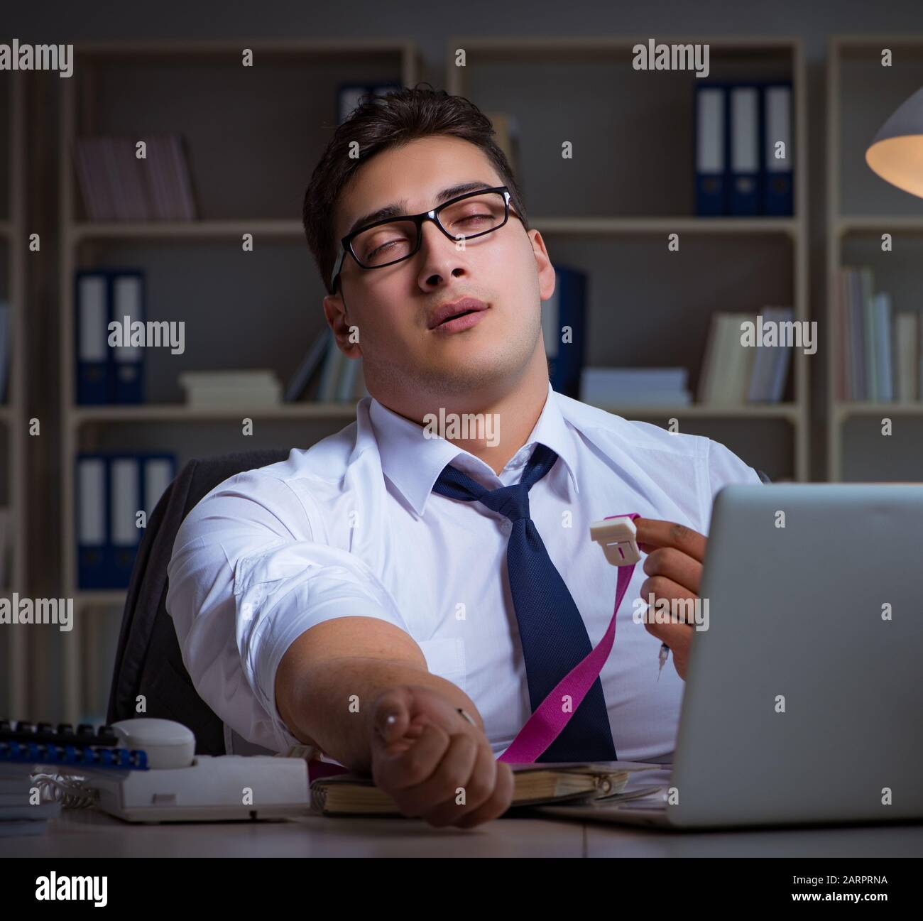 The businessman staying late in office for drugs Stock Photo - Alamy