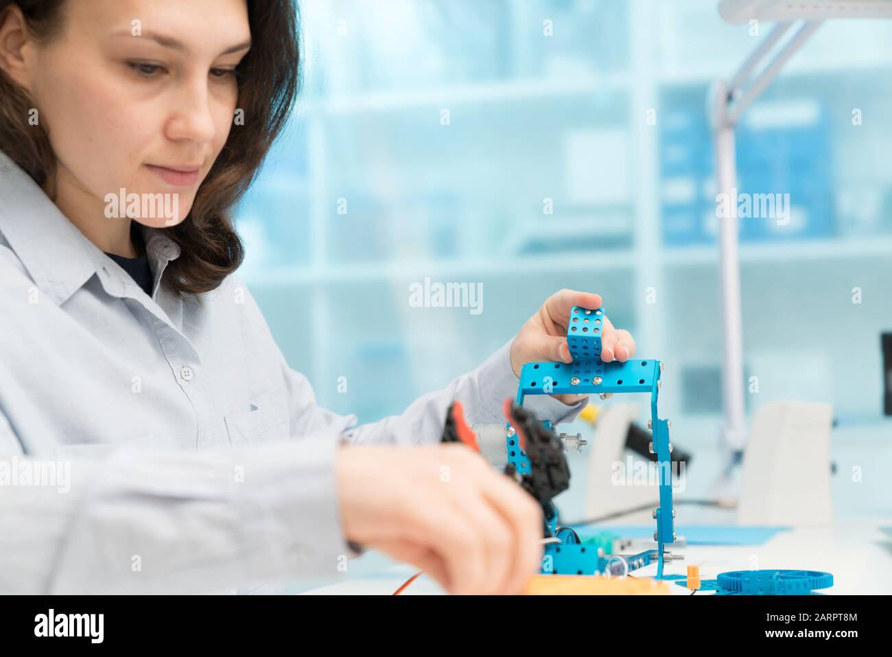 Student woman in robotics laboratory working on project mechatronics ...
