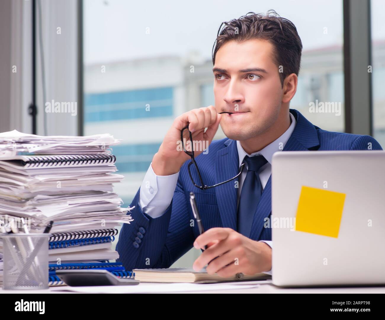 The workaholic businessman overworked with too much work in office ...