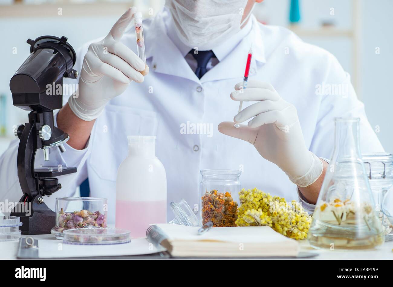 The chemist mixing perfumes in the lab Stock Photo - Alamy