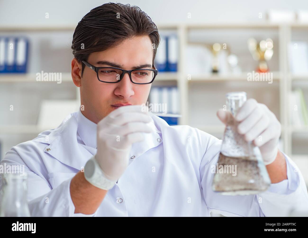 Young researcher scientist doing a water test contamination experiment ...