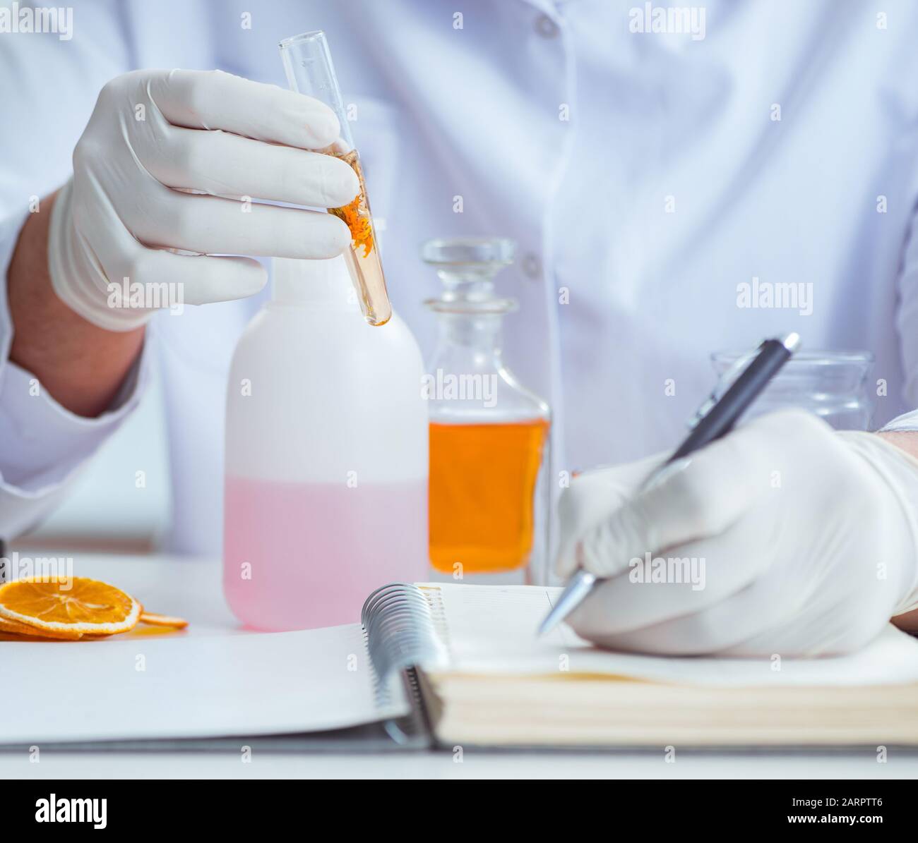 The chemist mixing perfumes in the lab Stock Photo - Alamy