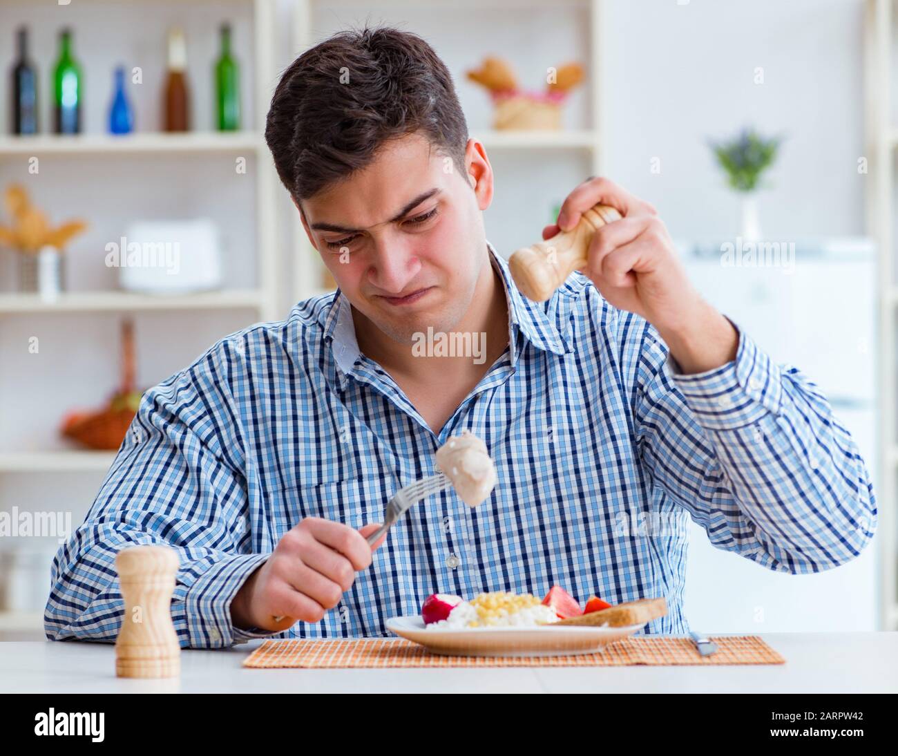 The man eating tasteless food at home for lunch Stock Photo - Alamy